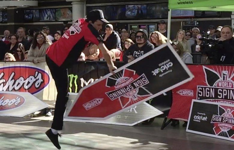 Sign spinners’ moves nab attention on street and at contest | The ...