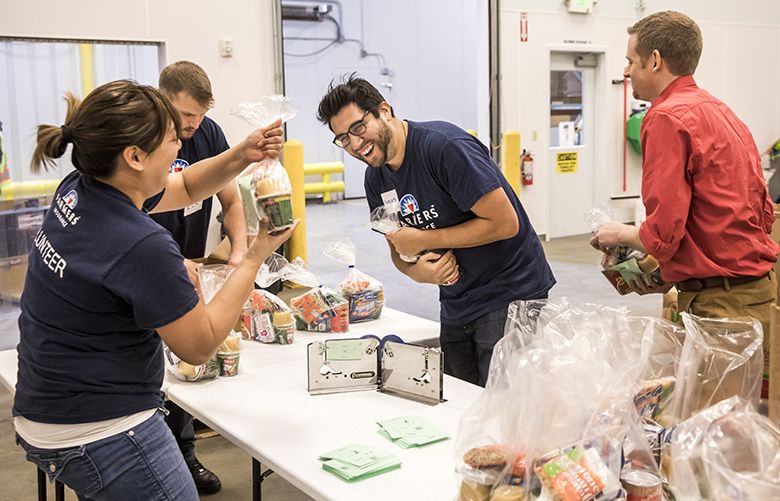 A volunteer shift at Northwest Harvest builds muscles while filling ...