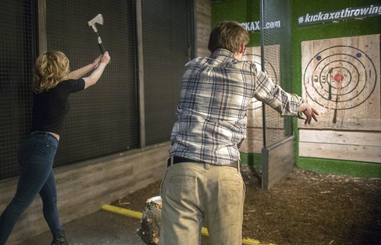 Downing beers and throwing axes: the latest bar craze | The Seattle Times