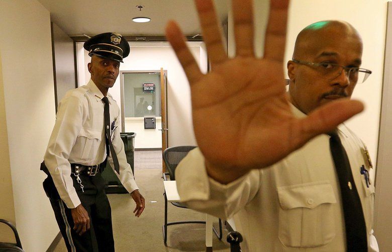 U.S. State Department officials stand guard outside closed Russian ...