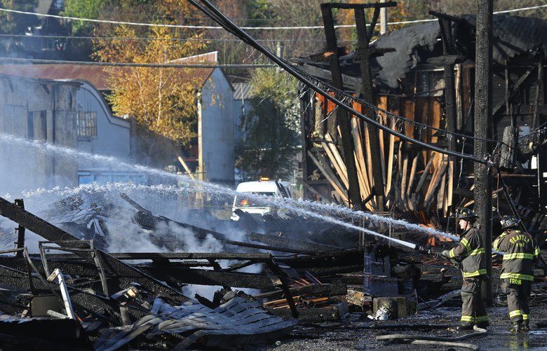 Four-alarm fire at lumber yard on Seattle’s Ship Canal still smoldering ...