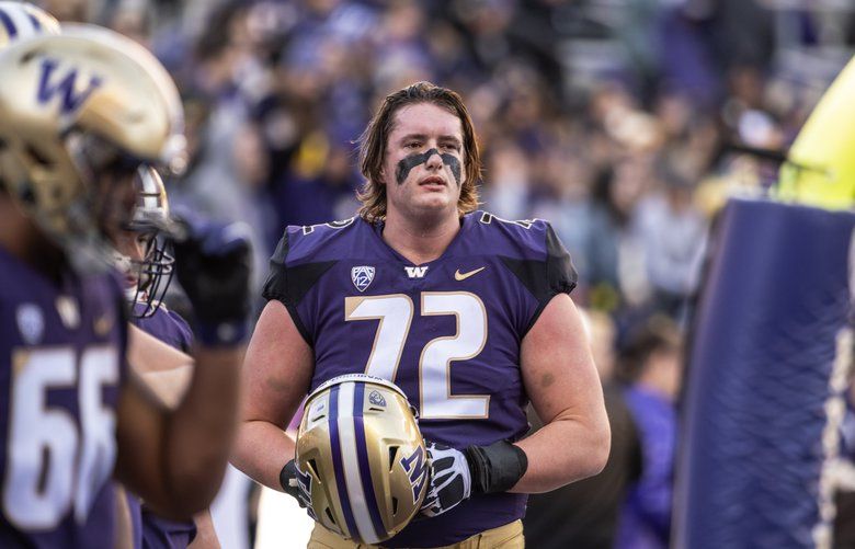 Huskies left tackle Trey Adams returns from back surgery, in uniform ...