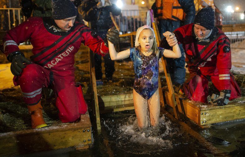 Russians plunge into icy waters to mark feast of Epiphany | The Seattle ...