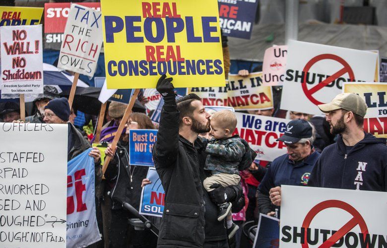 Federal employees rally outside Sea-Tac Airport to push for end of ...