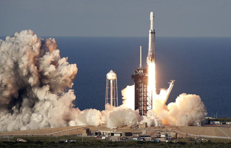 SpaceX launches mega rocket, lands all 3 boosters | The Seattle Times