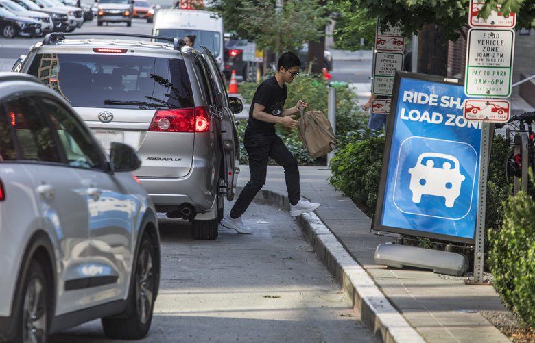 Seattle Uber and Lyft drivers often stop in the street to pick up or ...