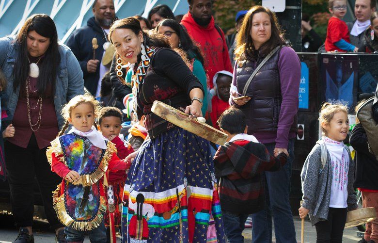 Native Americans march through downtown Seattle to celebrate Indigenous ...
