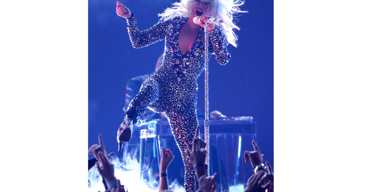 Lady Gaga falls off stage while dancing with fan | The Seattle Times