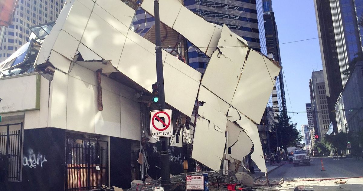 Demolition debris, hanging building facade close part of downtown ...