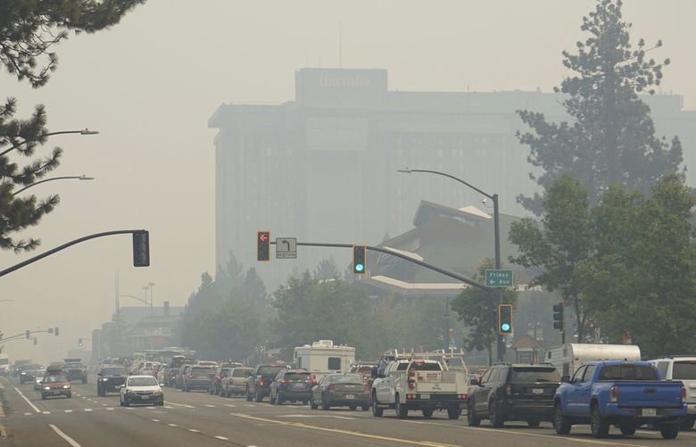 Huge wildfire near Lake Tahoe slows as weather improves | The Seattle Times
