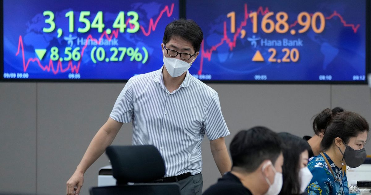Asian shares slip as Fed signals ‘downshift’ in economy | The Seattle Times