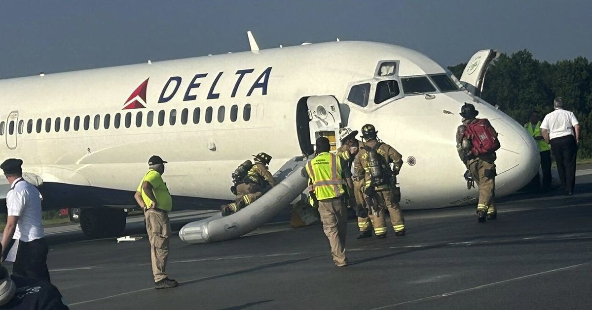 Delta passengers exit flight using jet slide after plane lands without ...