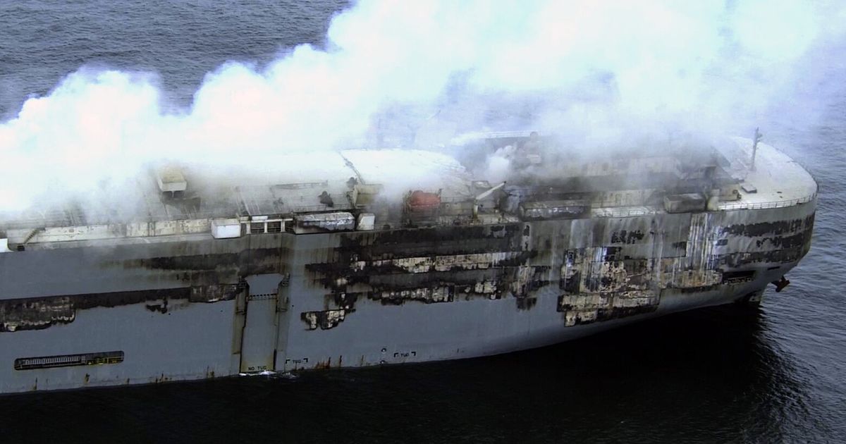 Salvage crews board a cargo ship burning off the Netherlands. The smoke ...