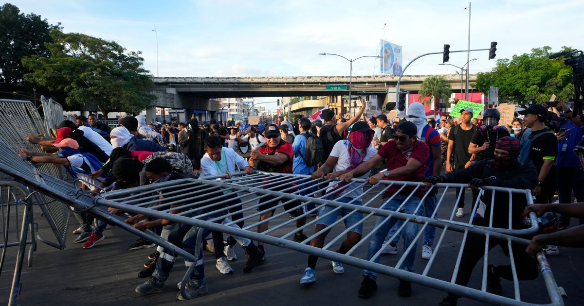 Protesters march in Panama against the contract extension for a huge ...