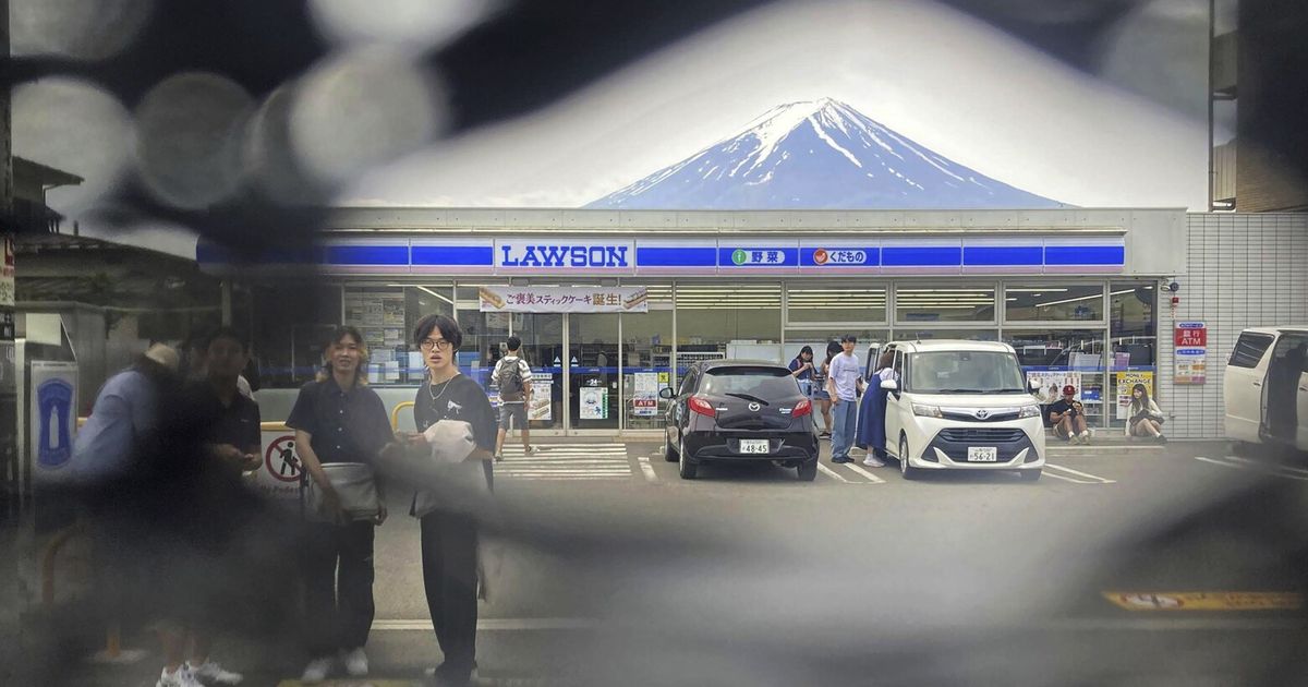 The screen set up to block tourist snapshots of Mount Fuji has several ...
