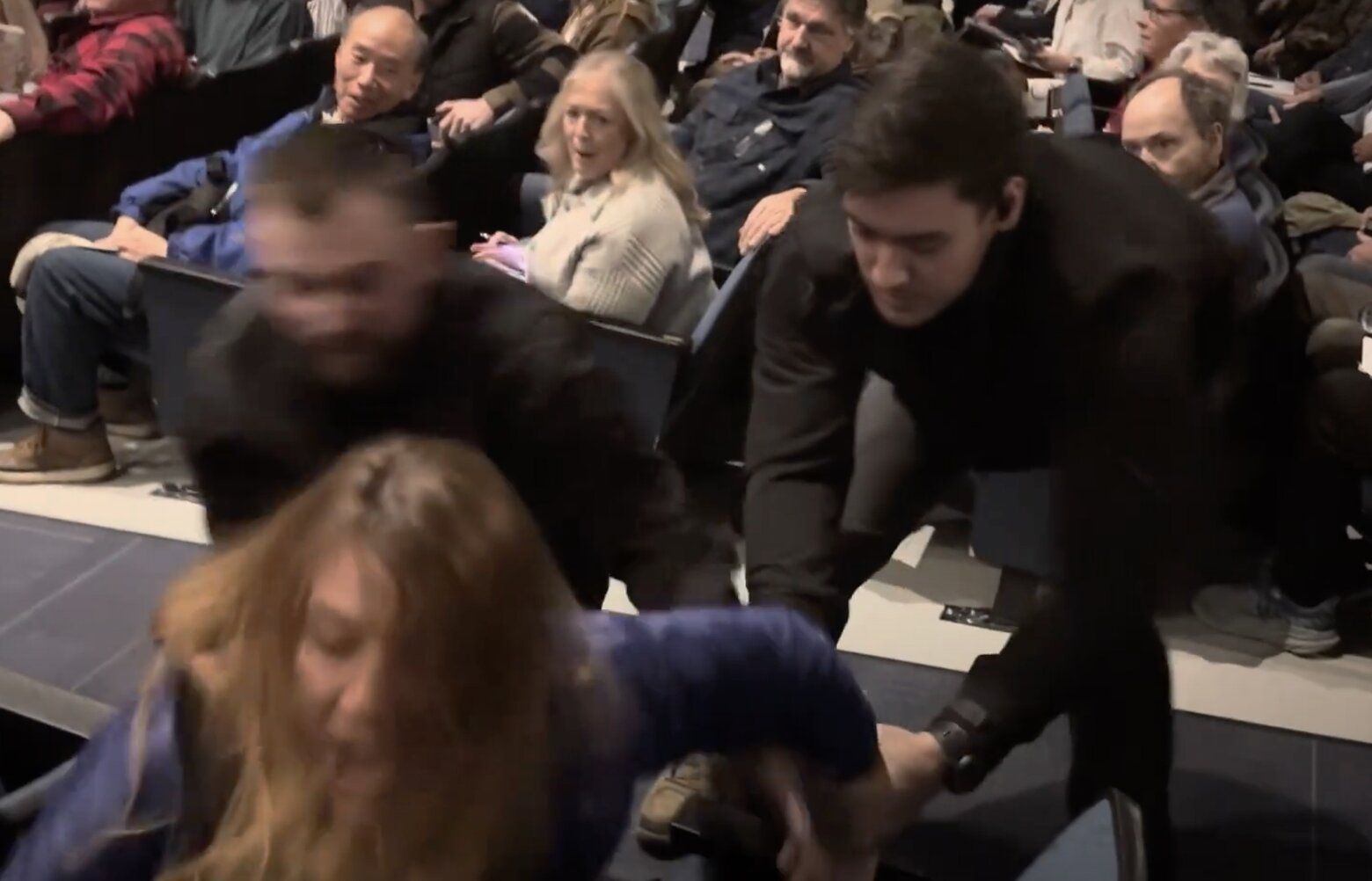 Idaho town hall meeting turns chaotic after woman is forcibly removed for shouting at speakers ...