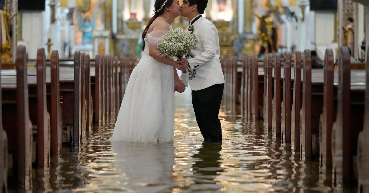 Photos show a Filipino couple walking down a flooded aisle on their wedding day | The Seattle Times